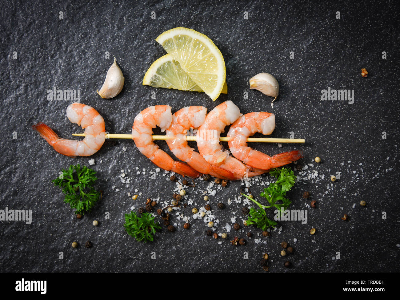Shrimps prawns in skewer sticks seafood cooked with herbs and spices on ...