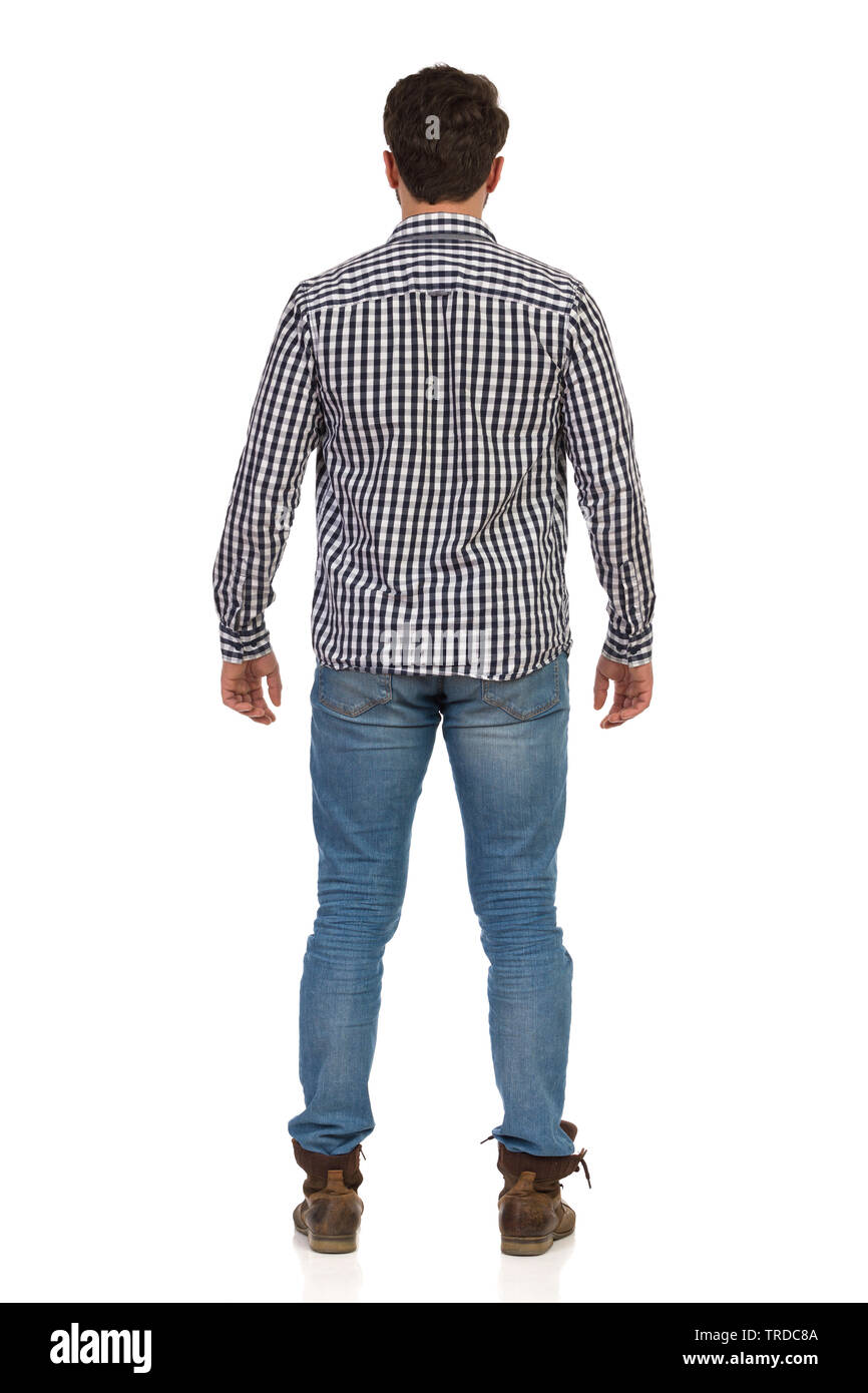 Man in jeans, boots and lumberjack shirt is standing relaxed. Rear view ... Man in jeans, boots and lumberjack shirt is standing relaxed. Rear view ...