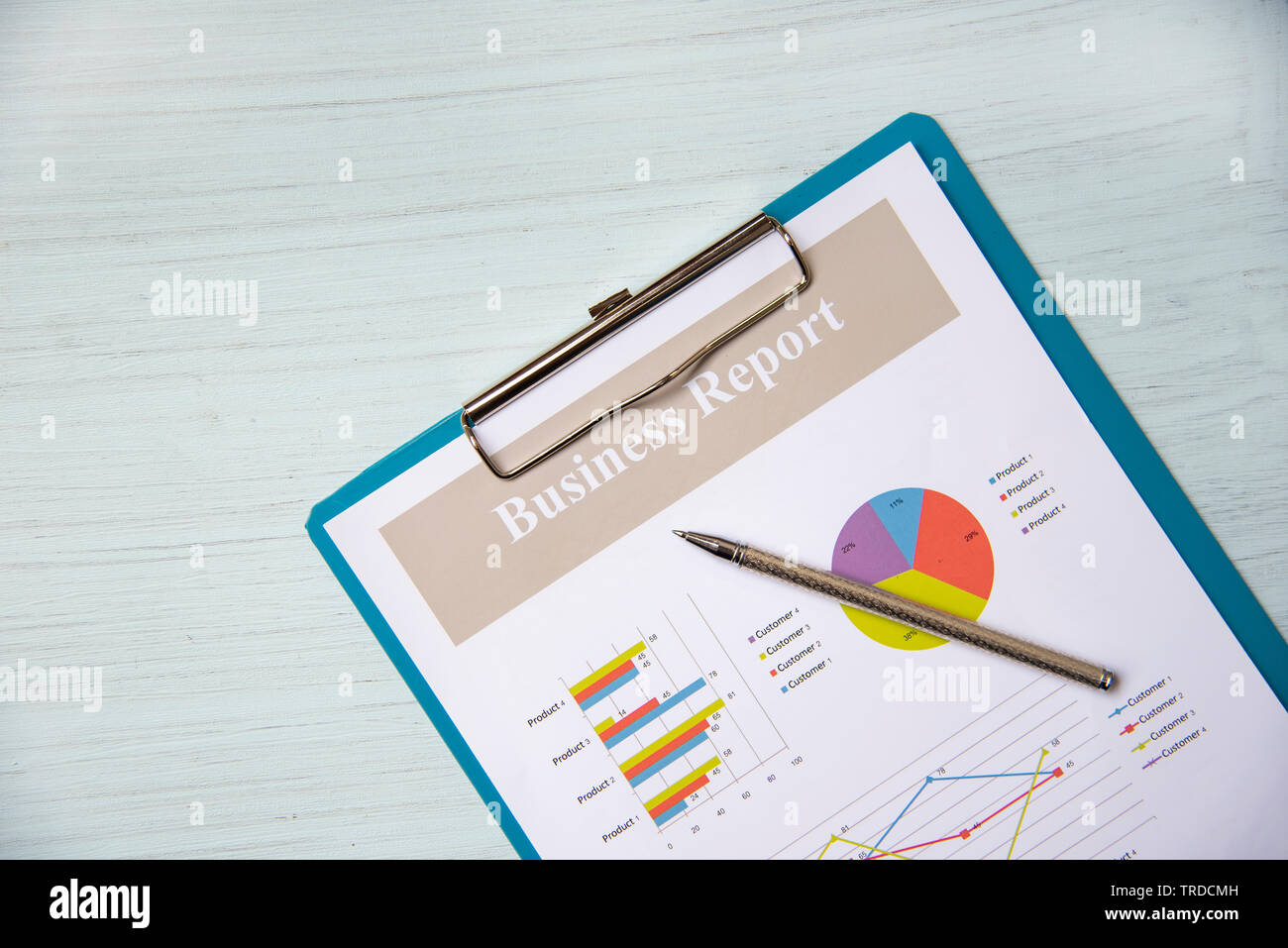 Business report graph chart and pen on report paper document present ...
