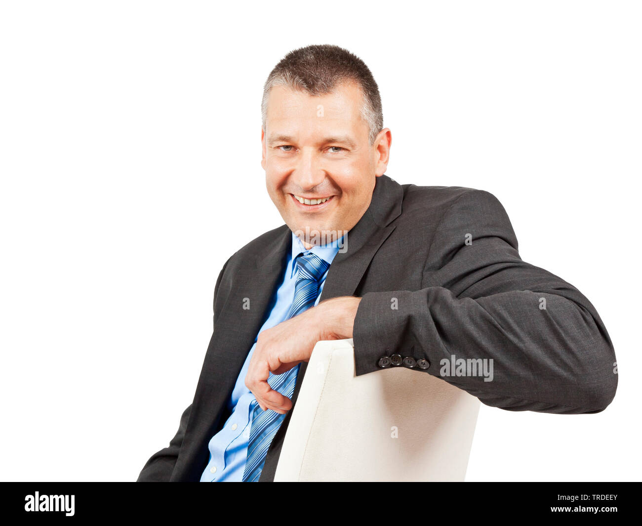 Portrait of a Businessman in a grey suit with one arm resting on the ...