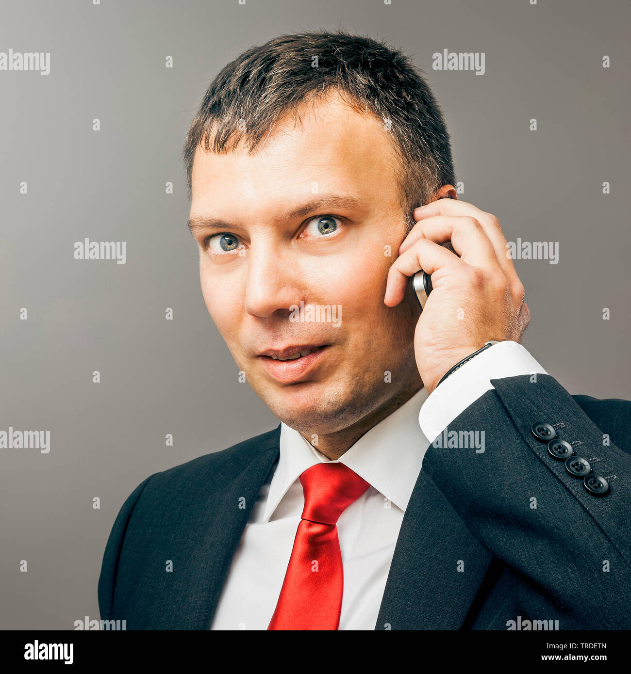 Portrait of a likeable Businessman in a black suit making a phone call ... Portrait of a likeable Businessman in a black suit making a phone call ...