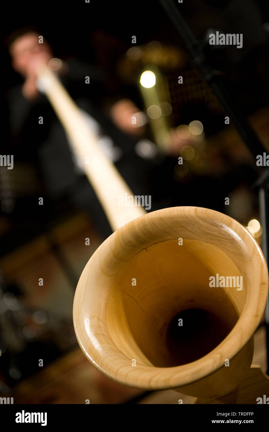 Musical instrument - alphorn blower Stock Photo - Alamy