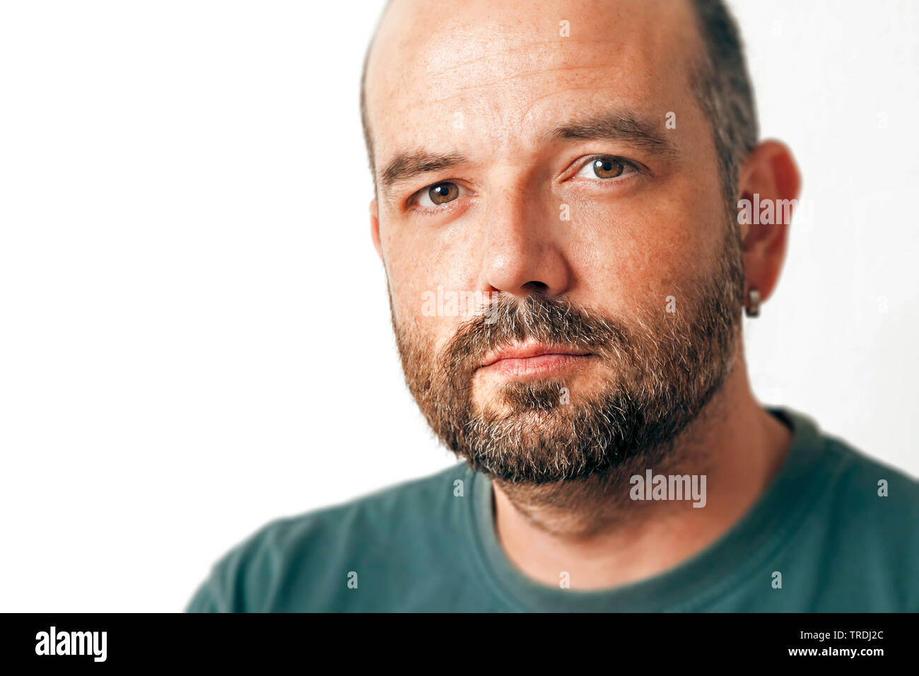 bearded sympathetic man in front of white background, Germany Stock ...