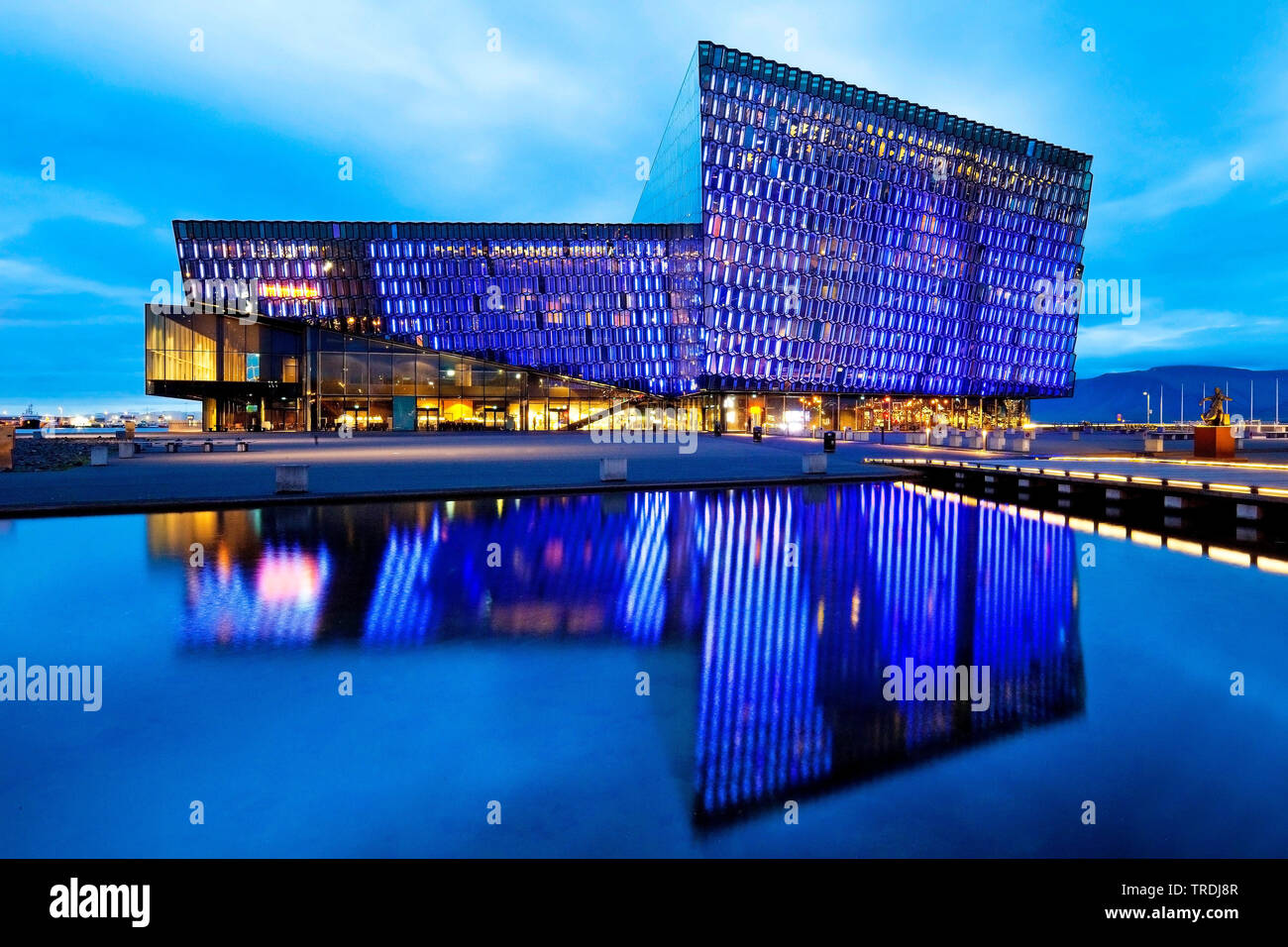 illuminated Harpa concert hall with distinctive colored glass facace in ...