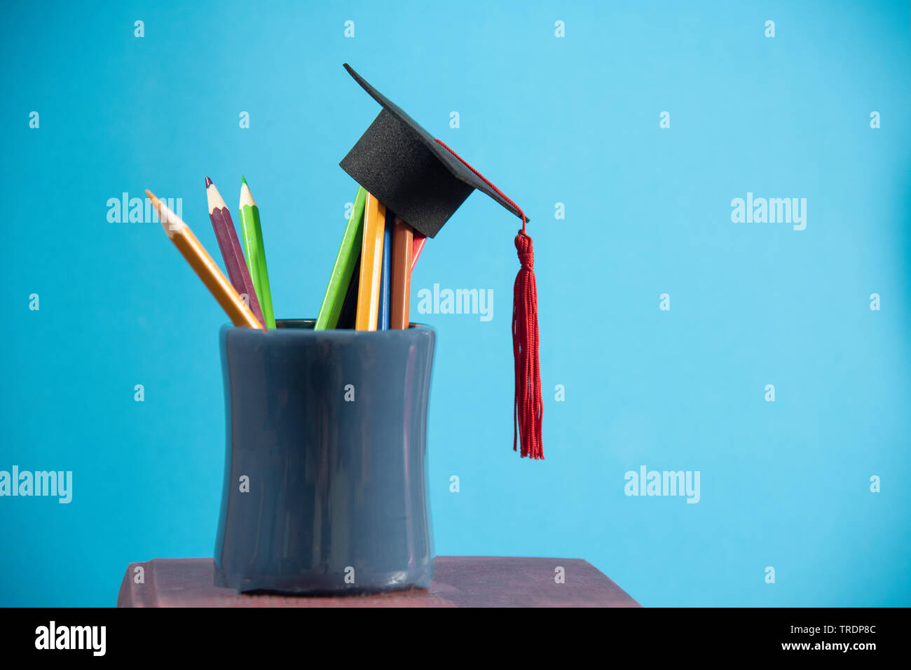 Education and back to school concept with graduation cap on pencils ...