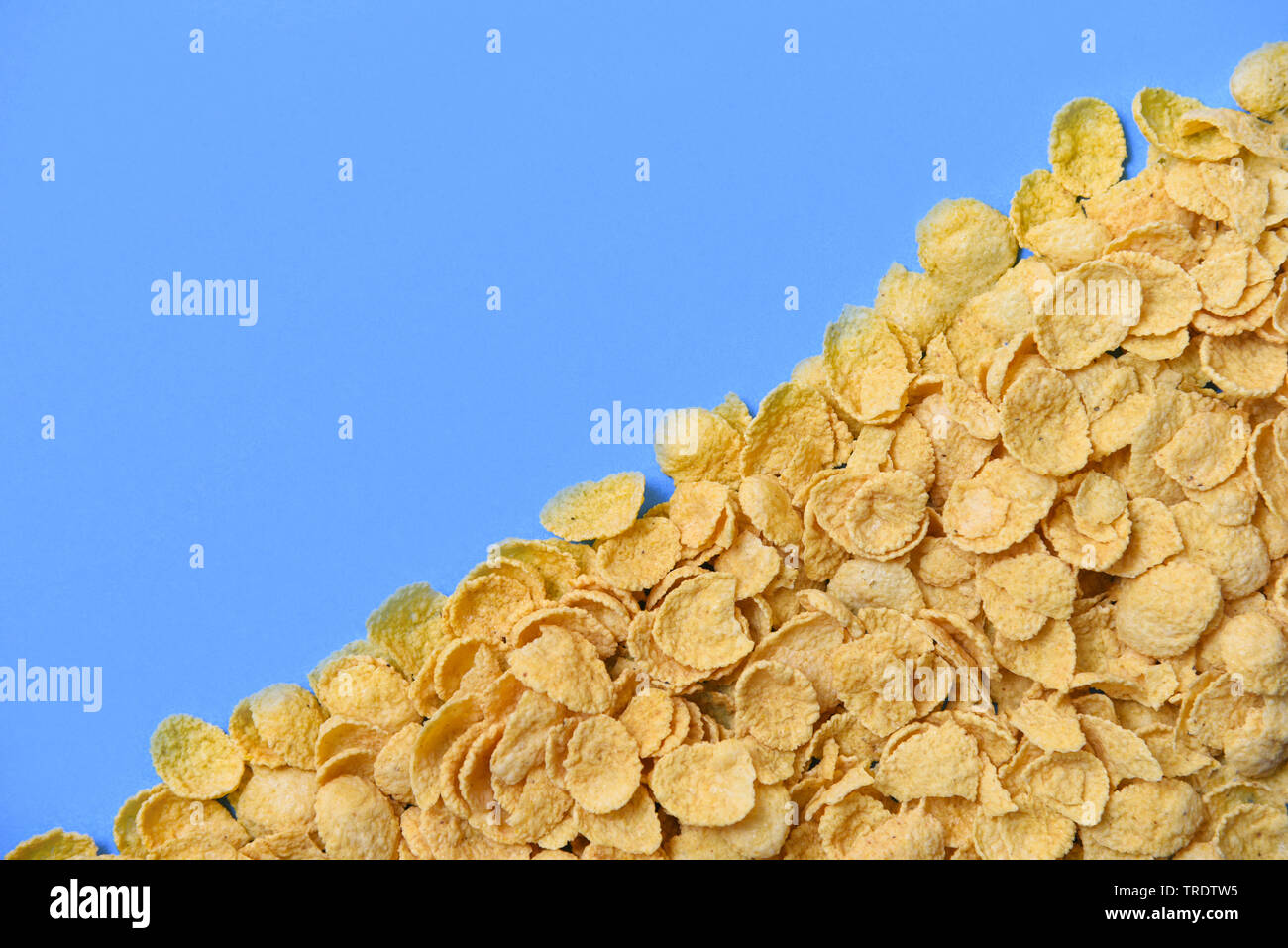 Cornflakes texture on blue background top view / Breakfast cornflake ...