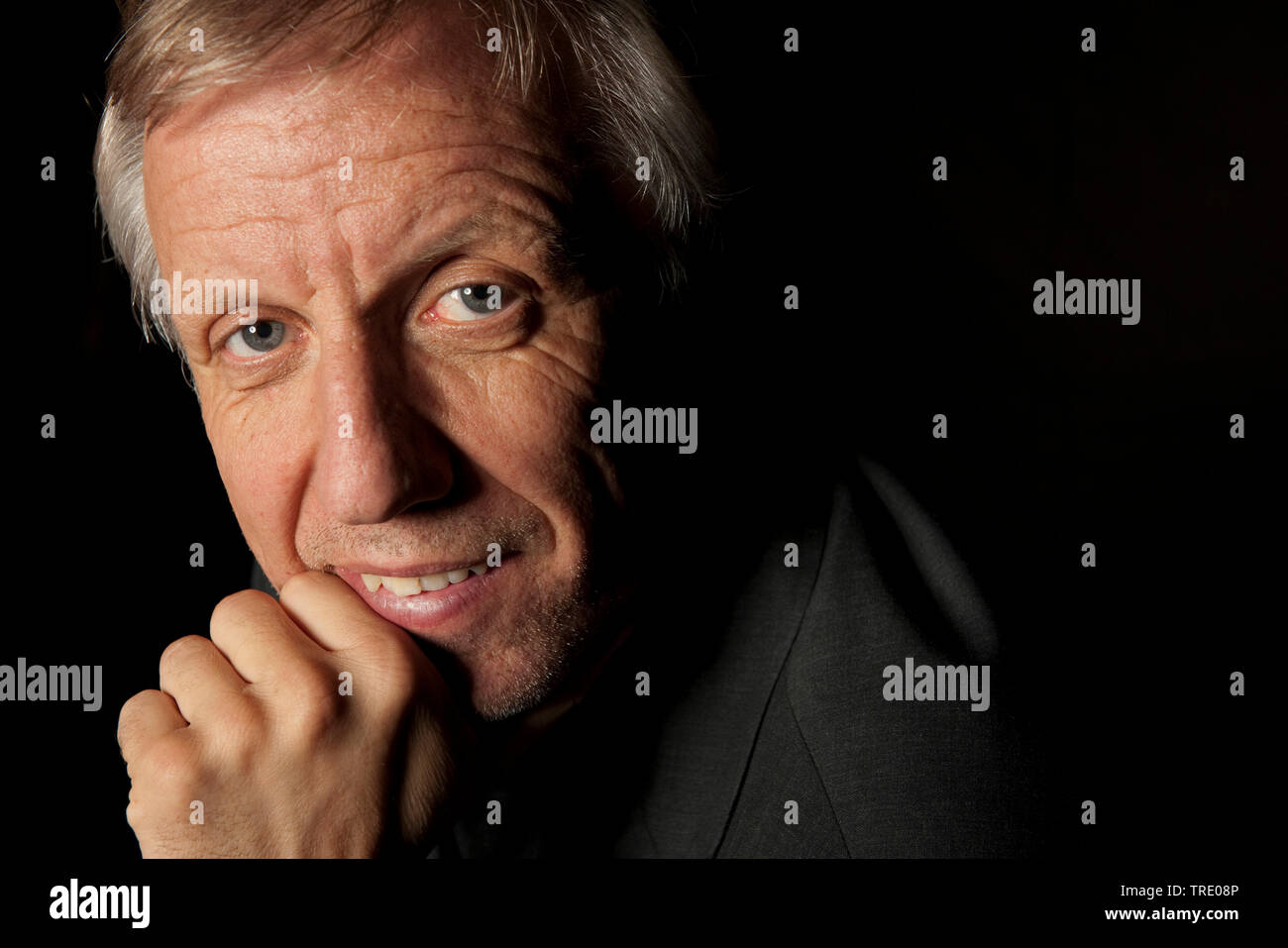 Portrait of an middle aged man with one hand on his chin Stock Photo ...