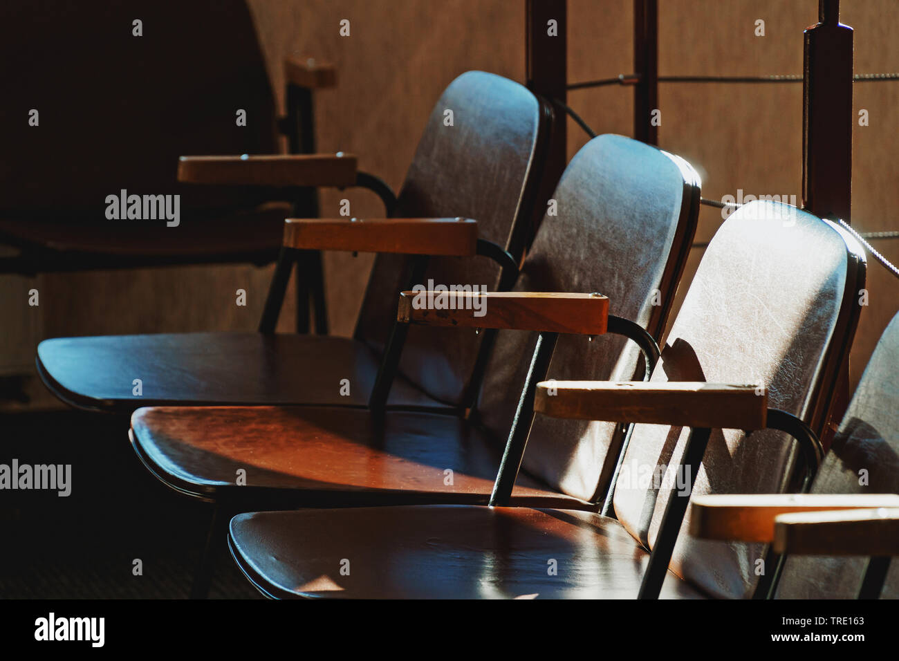 Row of old empty chairs covered with brown fake leather Stock Photo - Alamy