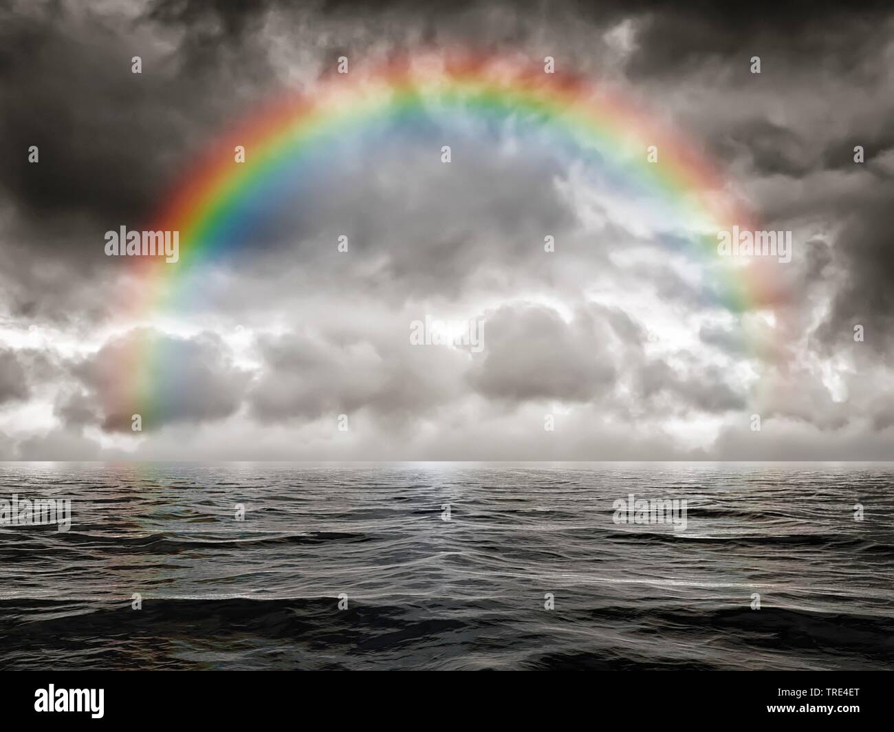 Rainbow in front of heavy clouds on the open part of the ocean Stock ...