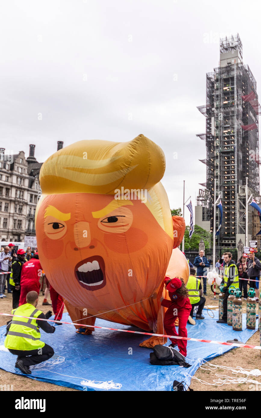 Protesters inflating a huge Donald Trump effigy balloon blimp outside ...