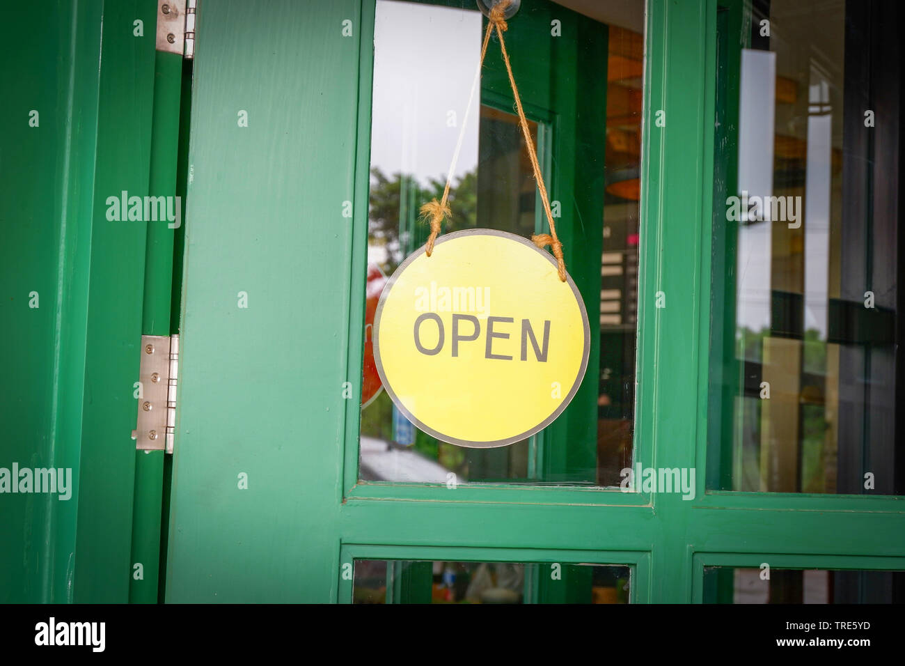 Open sign board yellow hanging on wooden door cafe Stock Photo - Alamy
