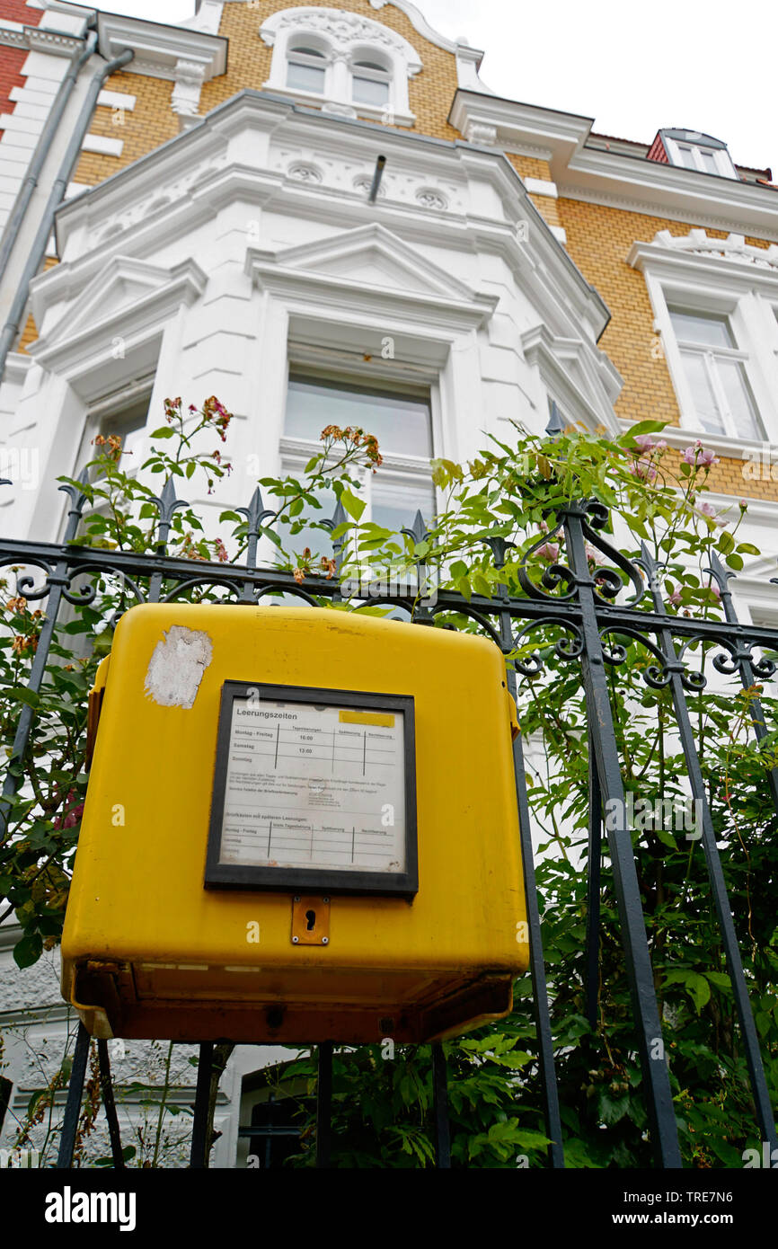 yellow letter box in front of an urban villa, Germany, North Rhine ...