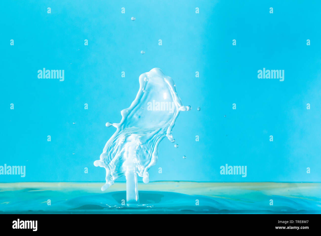 water drop falling and impacting a body of water after hitting the ...