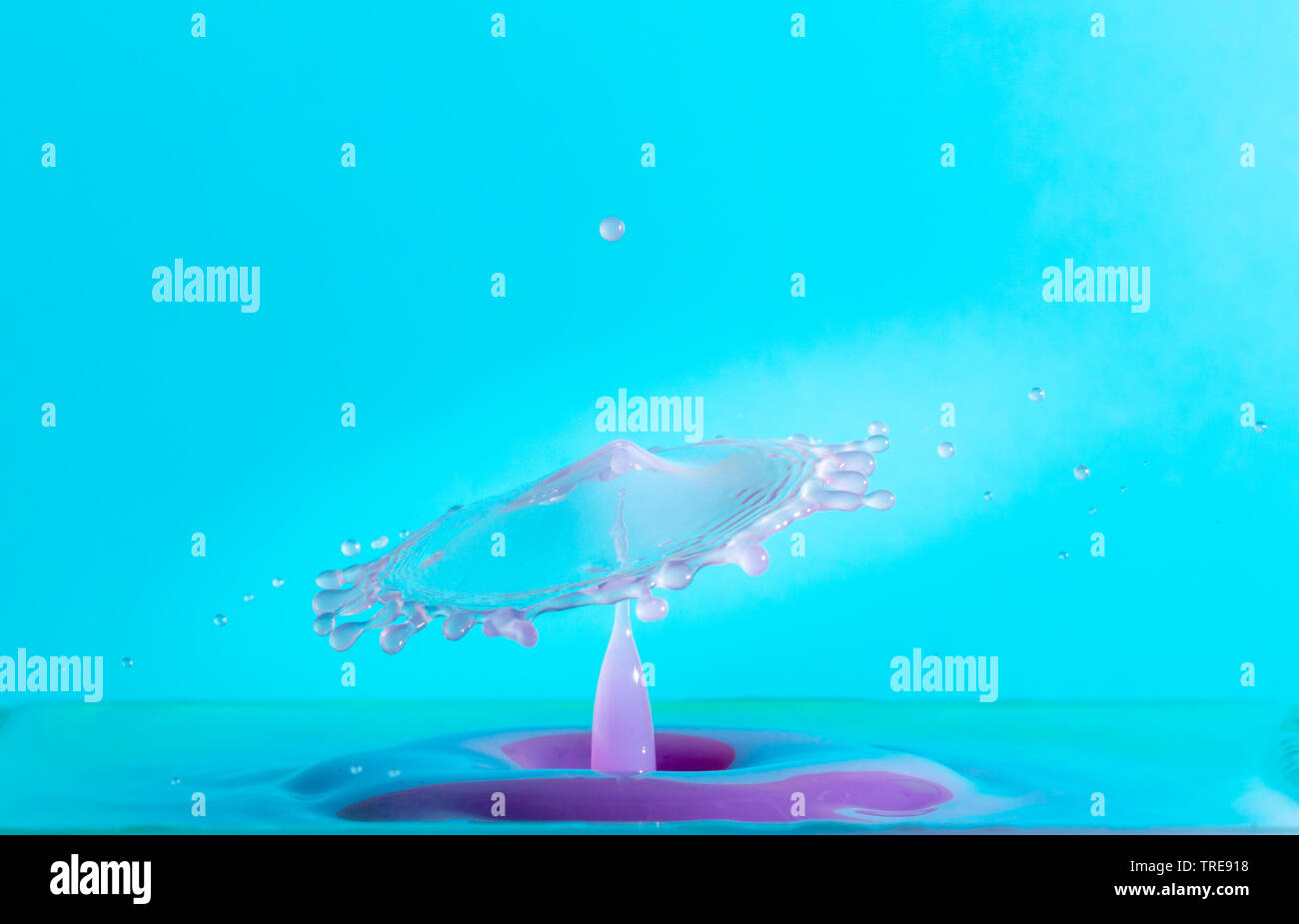 water drop falling and impacting a body of water after hitting the ...