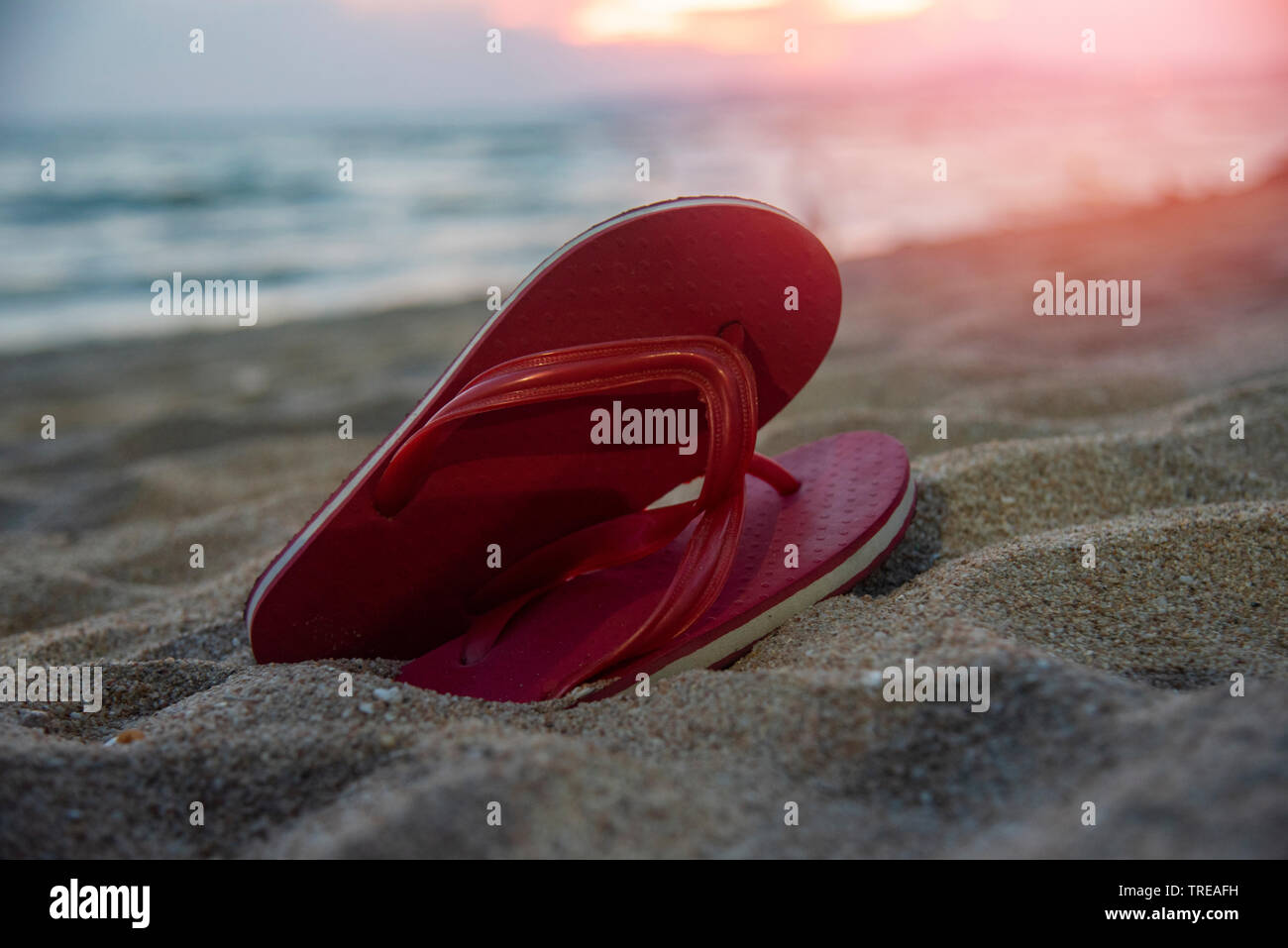 flip flops on beach with sandy beach sunset and ocean sea background ...