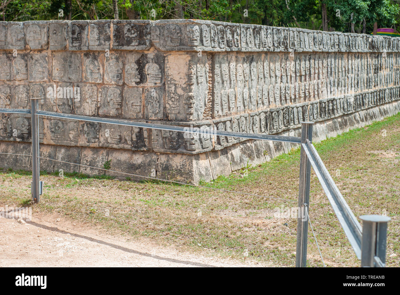 Mayan structure adorned with engraved skulls, in the archaeological ...