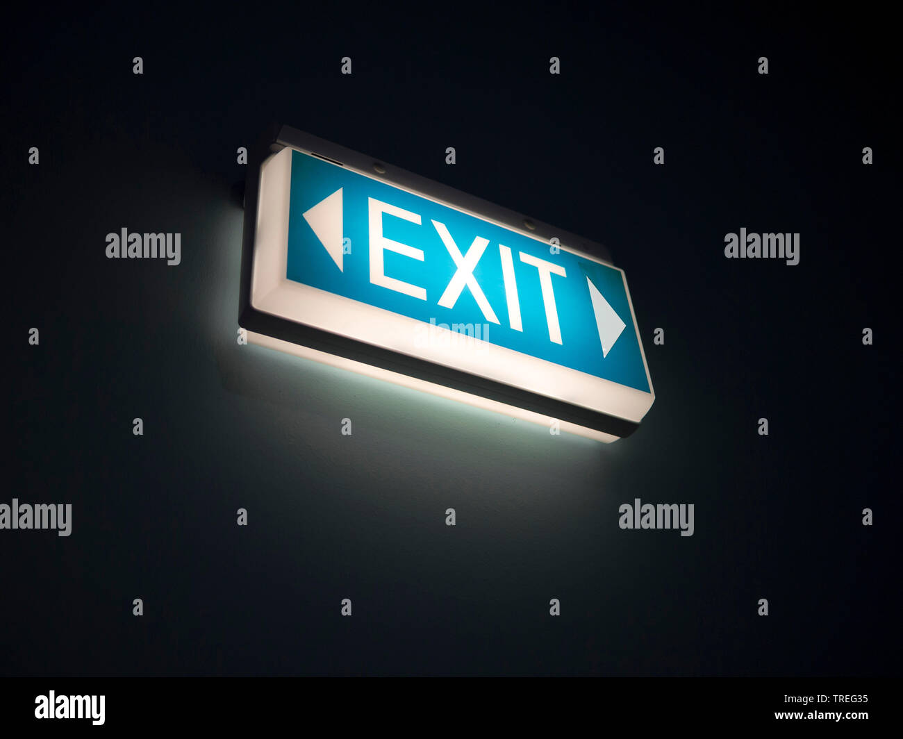 3D computer graphic, illuminated exit sign against blach background ...