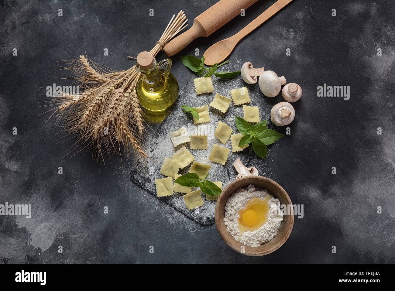 Italian raw ravioli with mushrooms, basil, flour, wheat, olive oil on ...