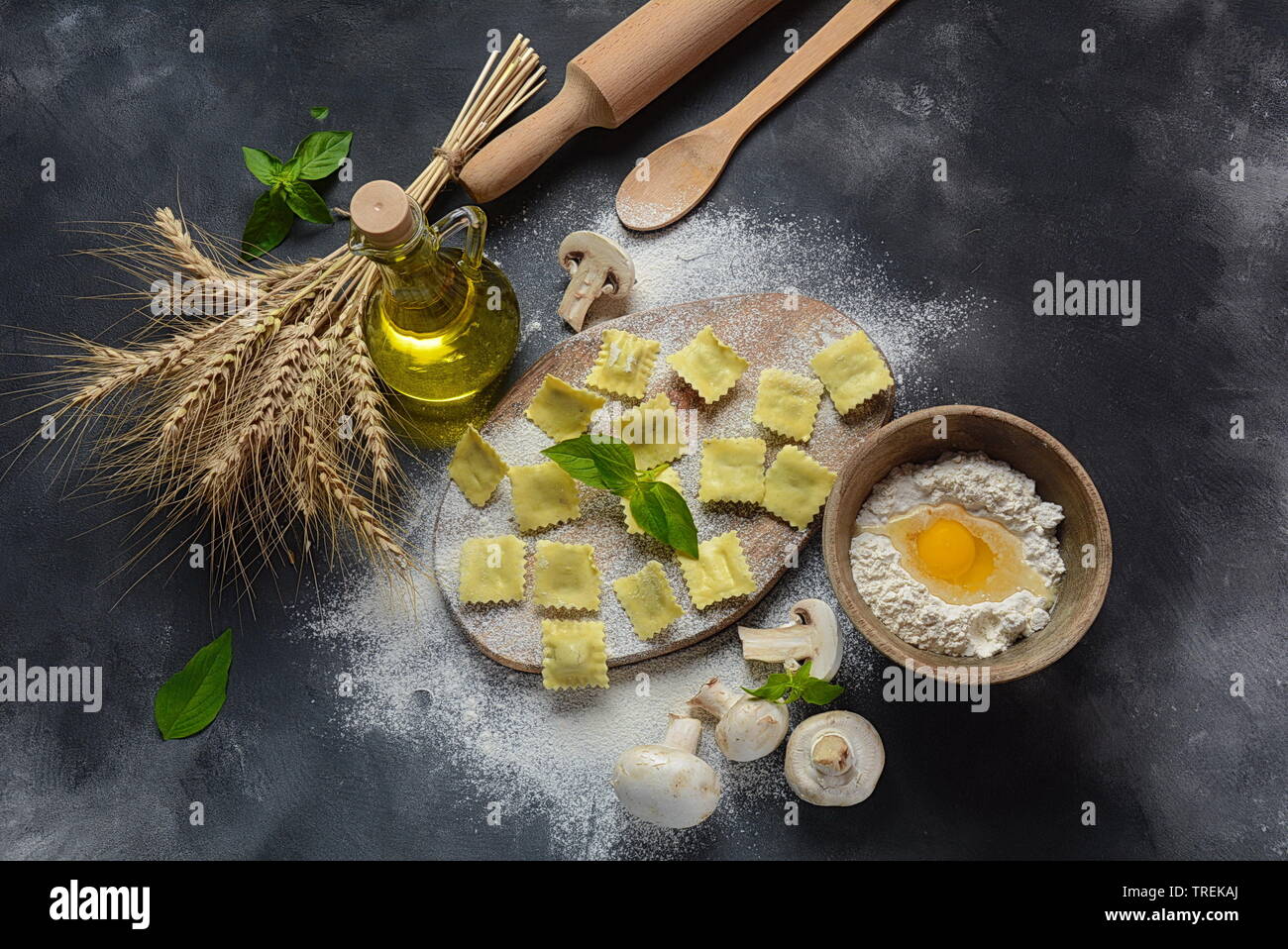 Italian raw ravioli with mushrooms, basil, flour, wheat, olive oil on ...