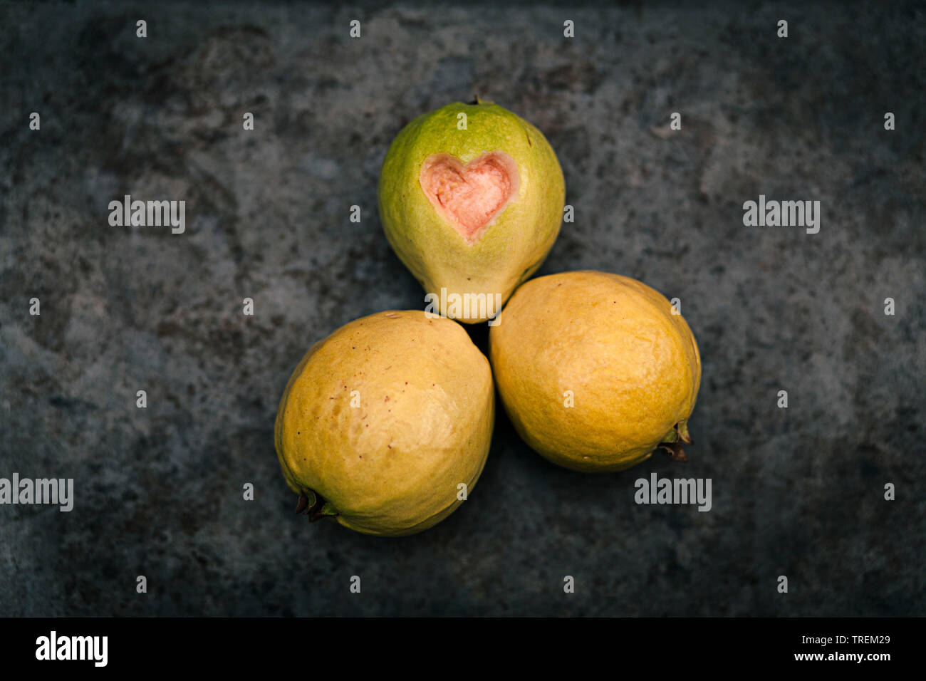 Closeup image of guava fruit with the shape of a heart carved out of ...