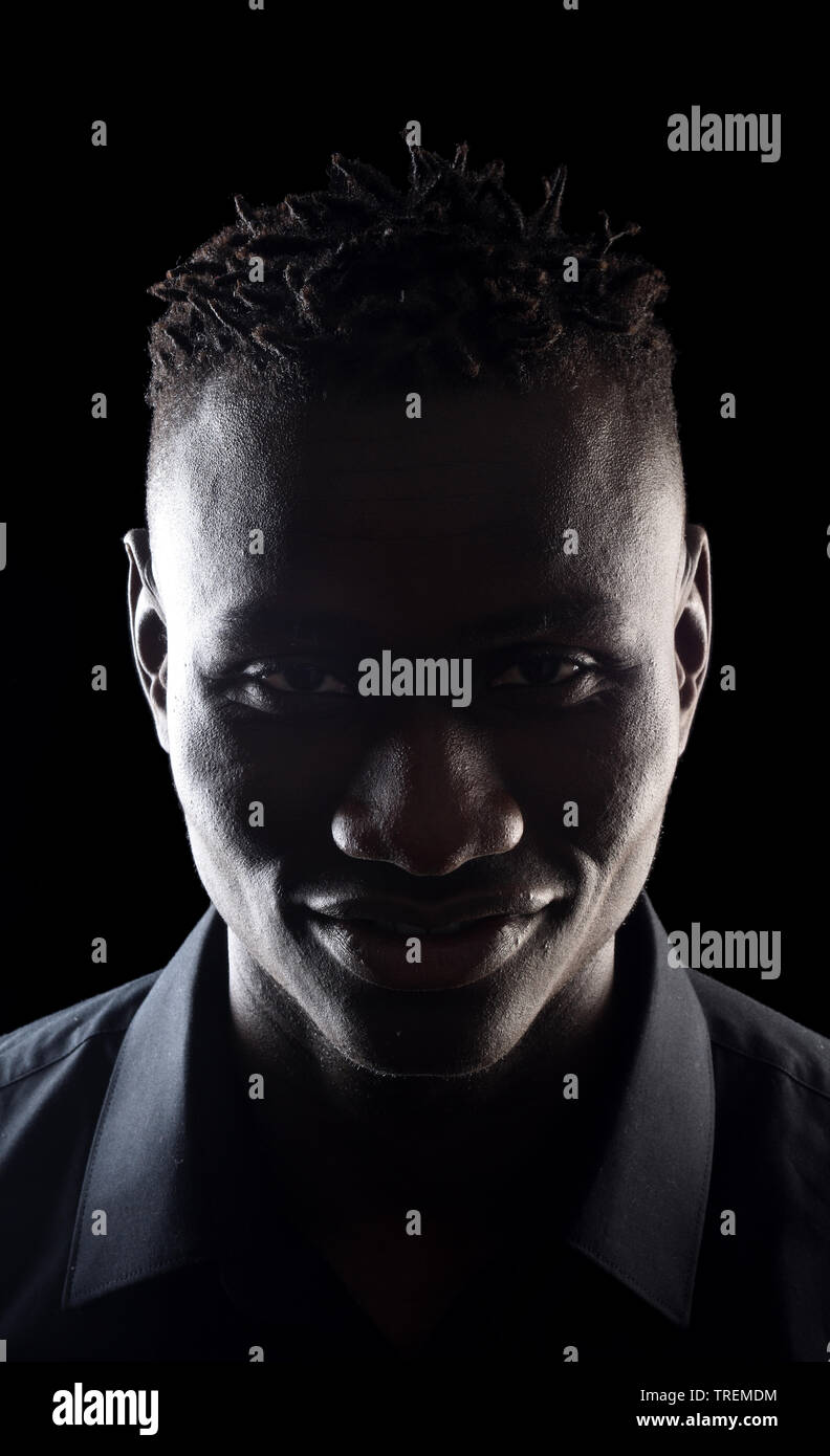 portrait of a african man on black background, smiling Stock Photo - Alamy