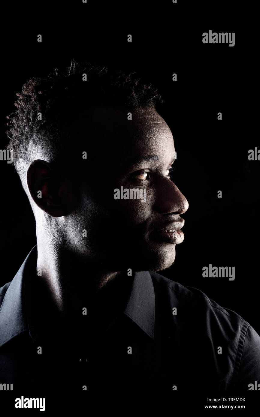 portrait of a african man on black background, profile Stock Photo - Alamy