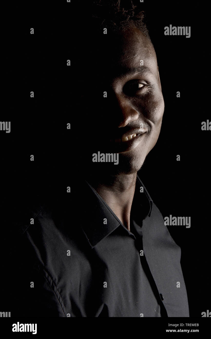 portrait of a african man on black background, smiling Stock Photo - Alamy