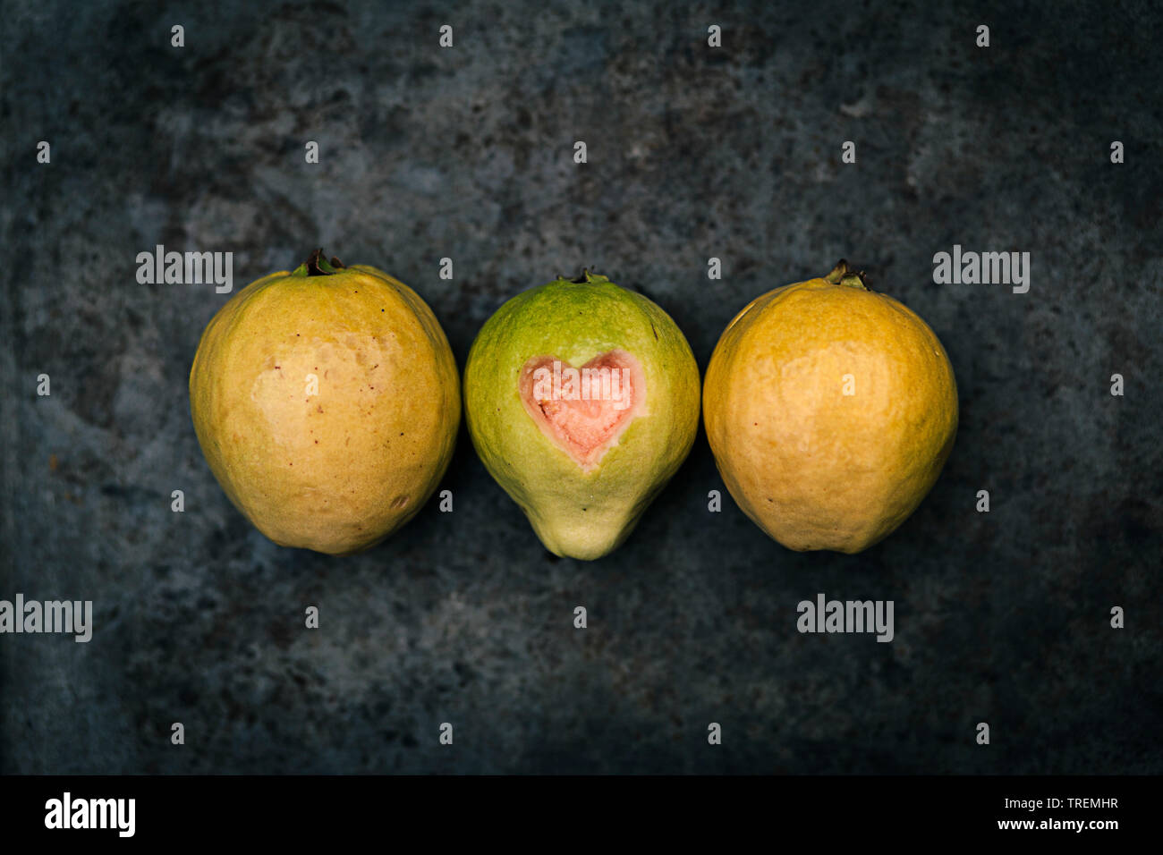 Closeup image of guava fruit with the shape of a heart carved out of ...
