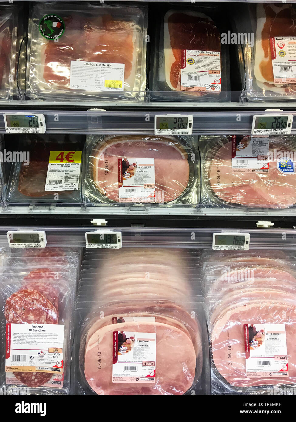 Processed pork meat wrapped in plastic film, on sale in a supermarket ...