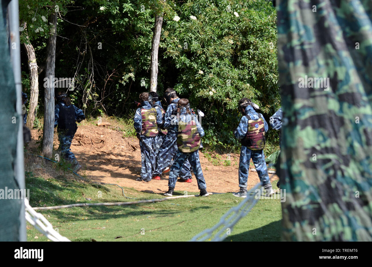 Battle at paintball. A small group of young players, fully equipped ...
