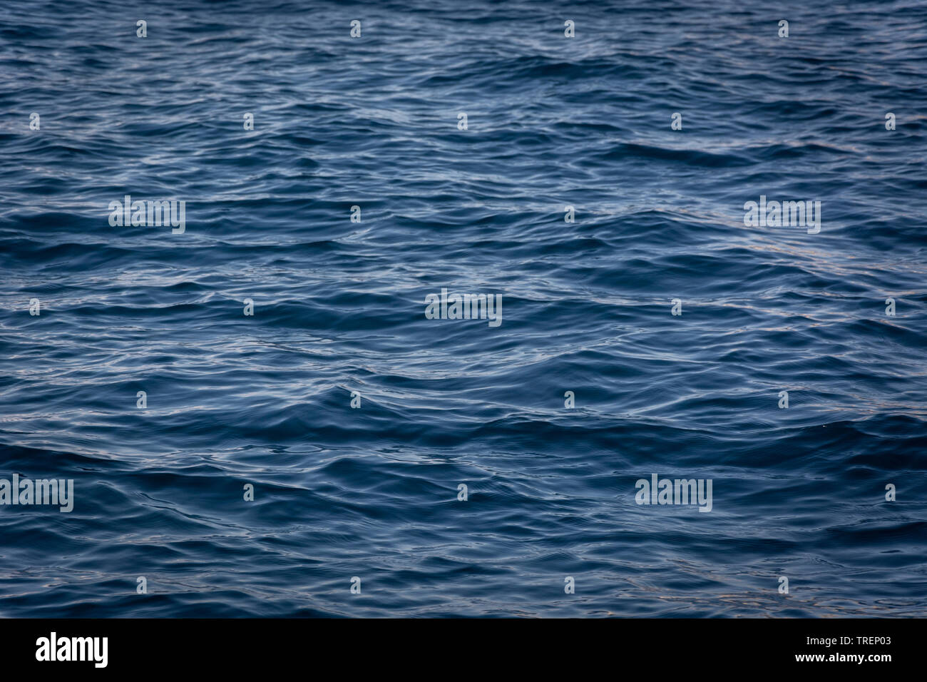 Dark blue sea water with calm waves texture or background Stock Photo ...