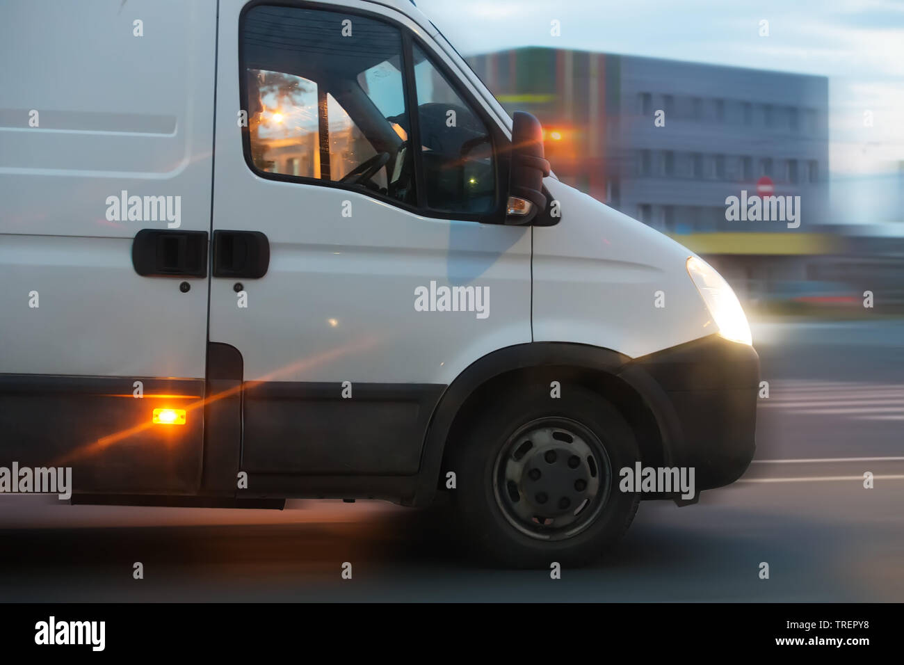 white minibus moves on the night city Stock Photo - Alamy