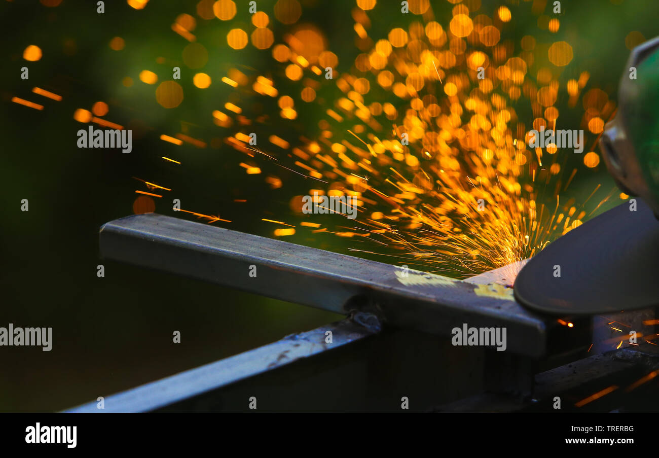 bright sparks of metal against dark background Stock Photo - Alamy