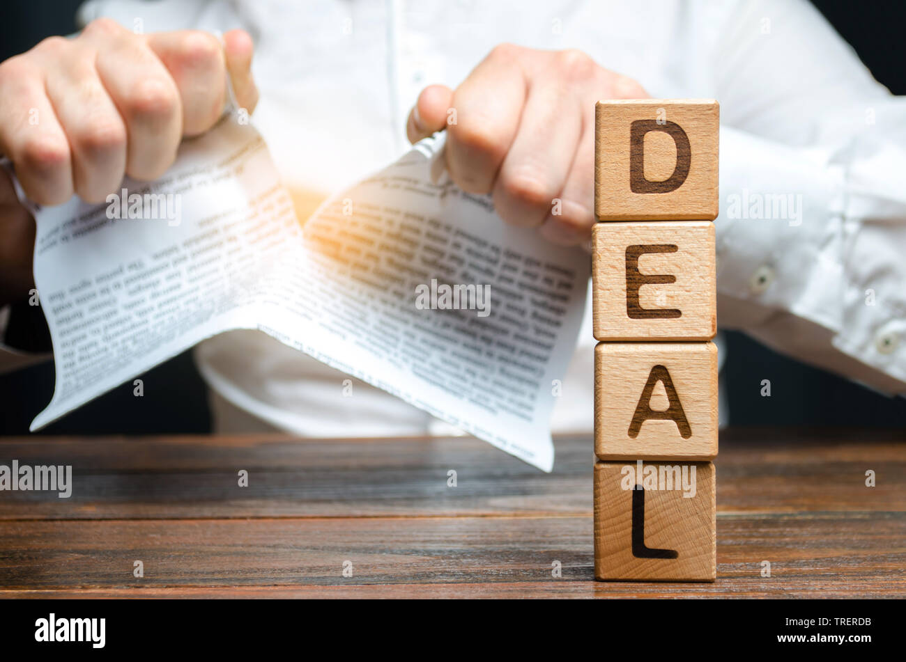 The word deal and businessman is breaking a contract in the background ...