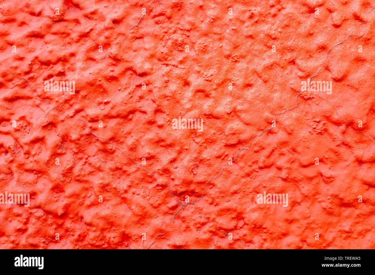 Background of a red stucco coated and painted exterior, rough cast of ...