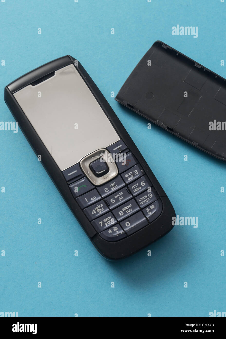 Old retro mobile phone on blue background, from above Stock Photo - Alamy