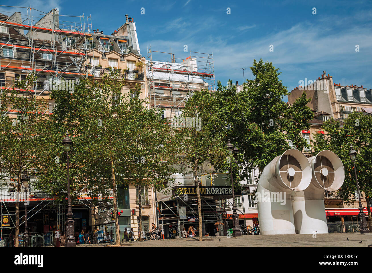 Facades of buildings in square with shops and exhaust pipelines at ...