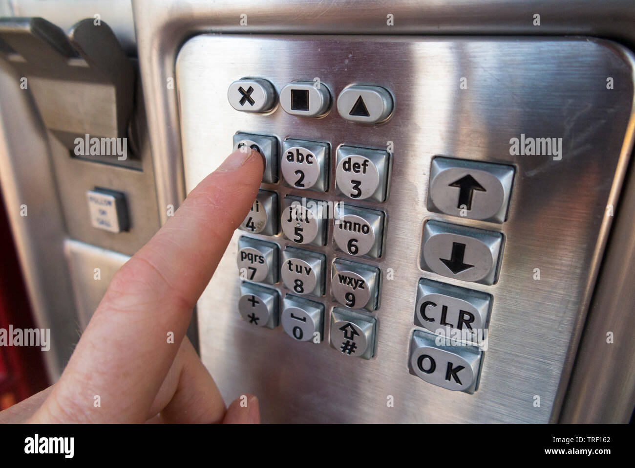 Person pushing the buttons to dial a number / dialling from a late ...