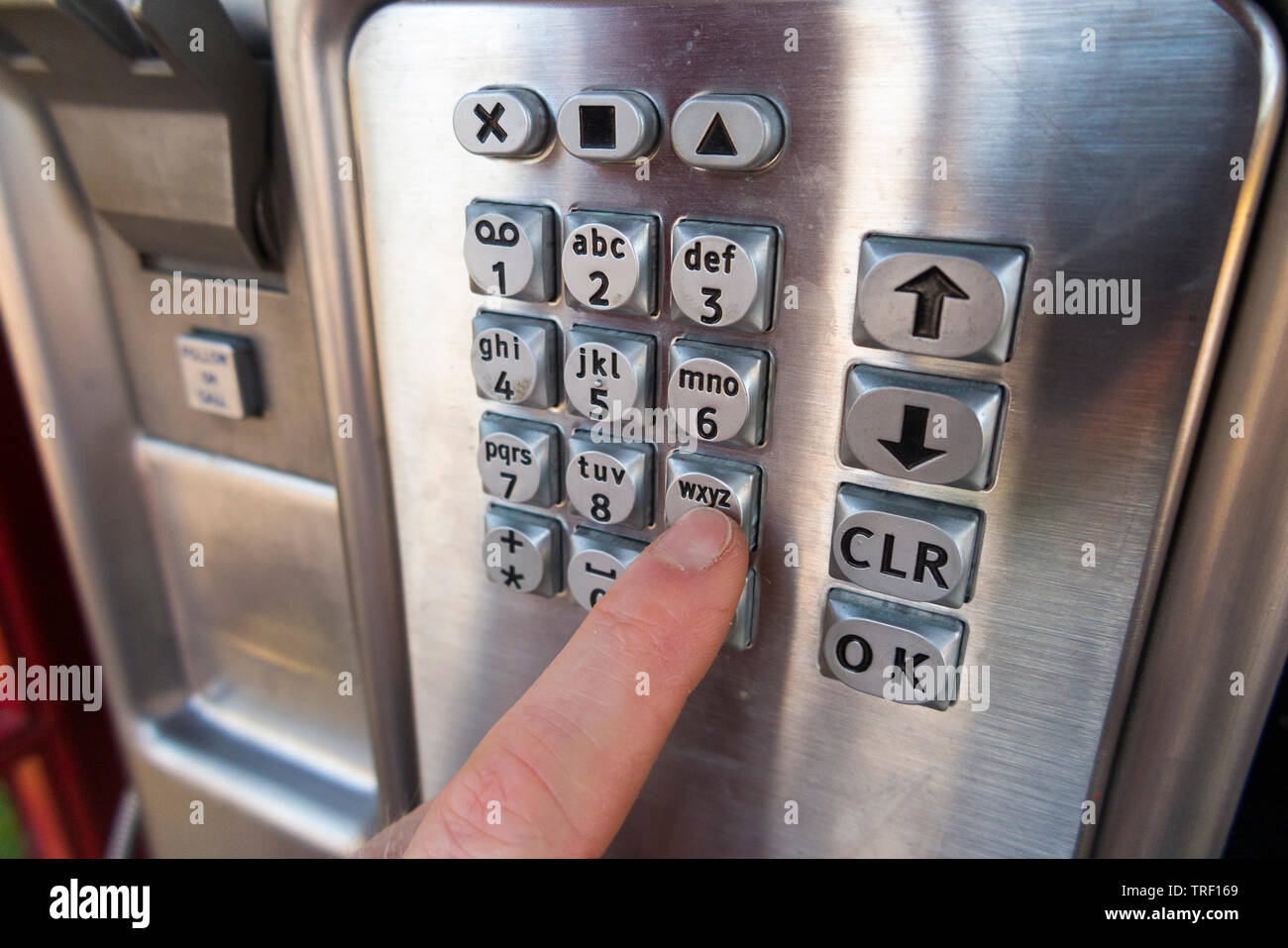 Person pushing the buttons to dial a number / dialling from a late ...