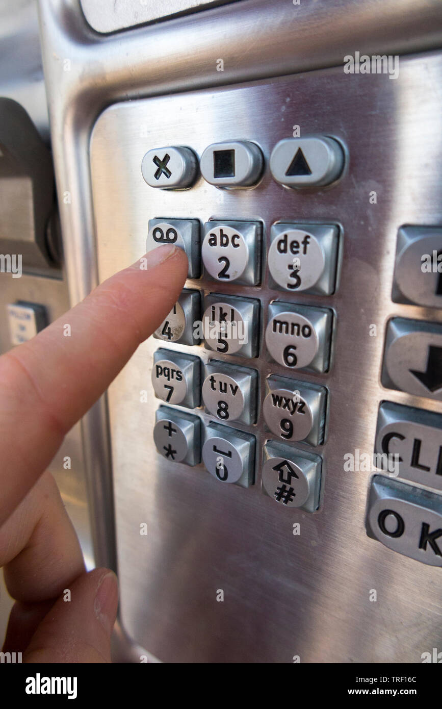 Person pushing the buttons to dial a number / dialling from a late ...