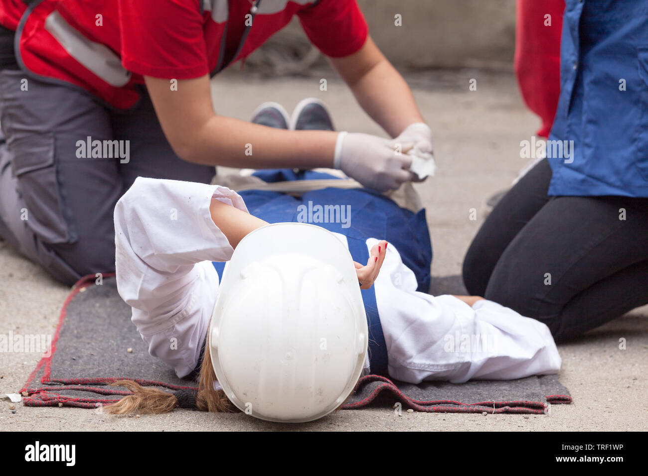 First aid training detail - helping an injured worker after a workplace ...