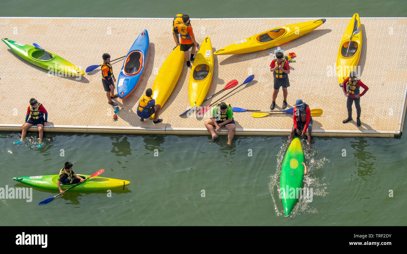 Boys on a pontoon getting ito kayaks to go paddling on Marina Bay ...