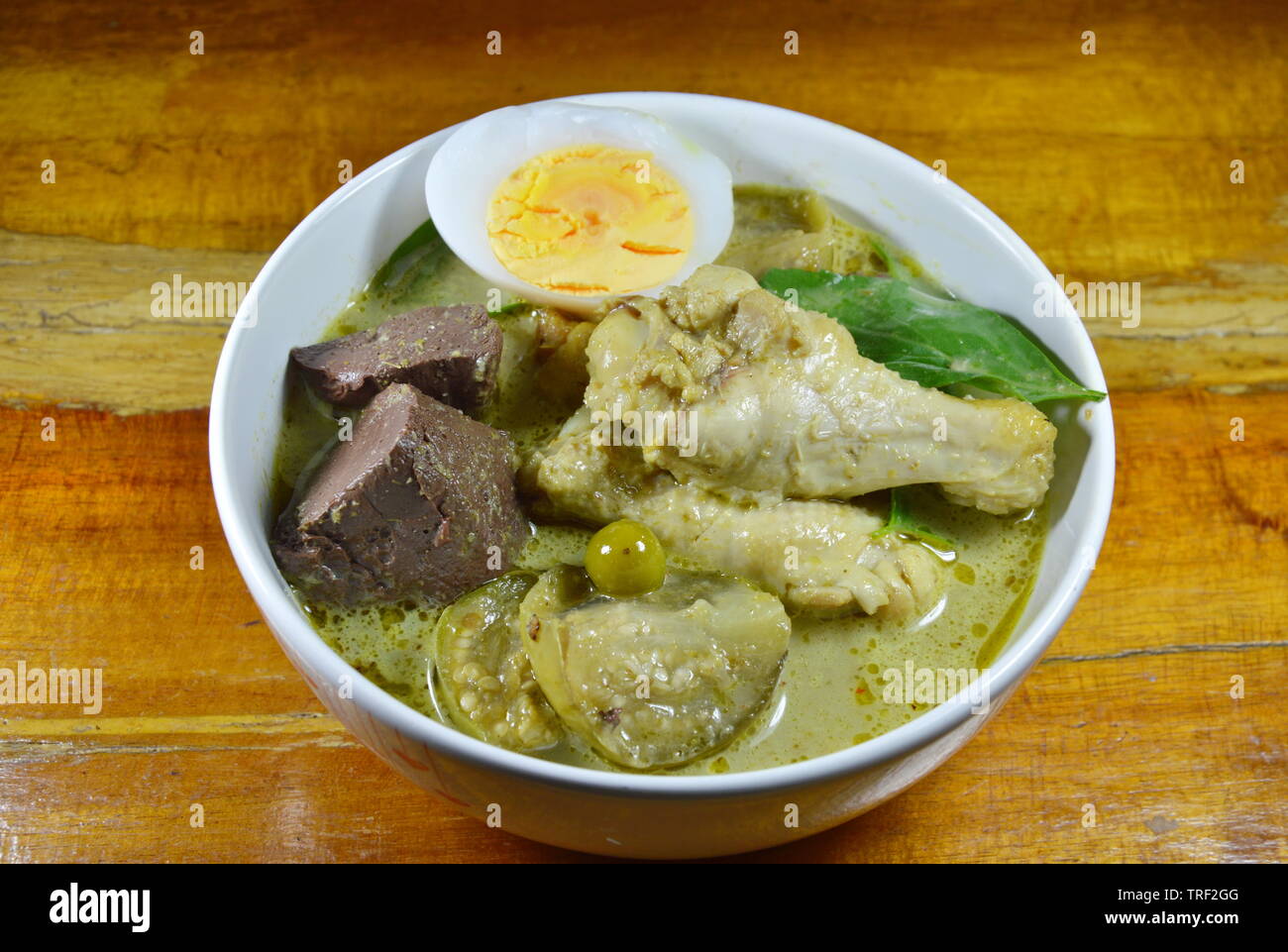 spicy chicken leg in green curry topping boiled egg on bowl Stock Photo ...