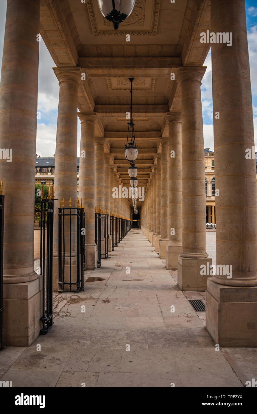Pathway with marble colonnade between courtyards at the Palais-Royal in ...