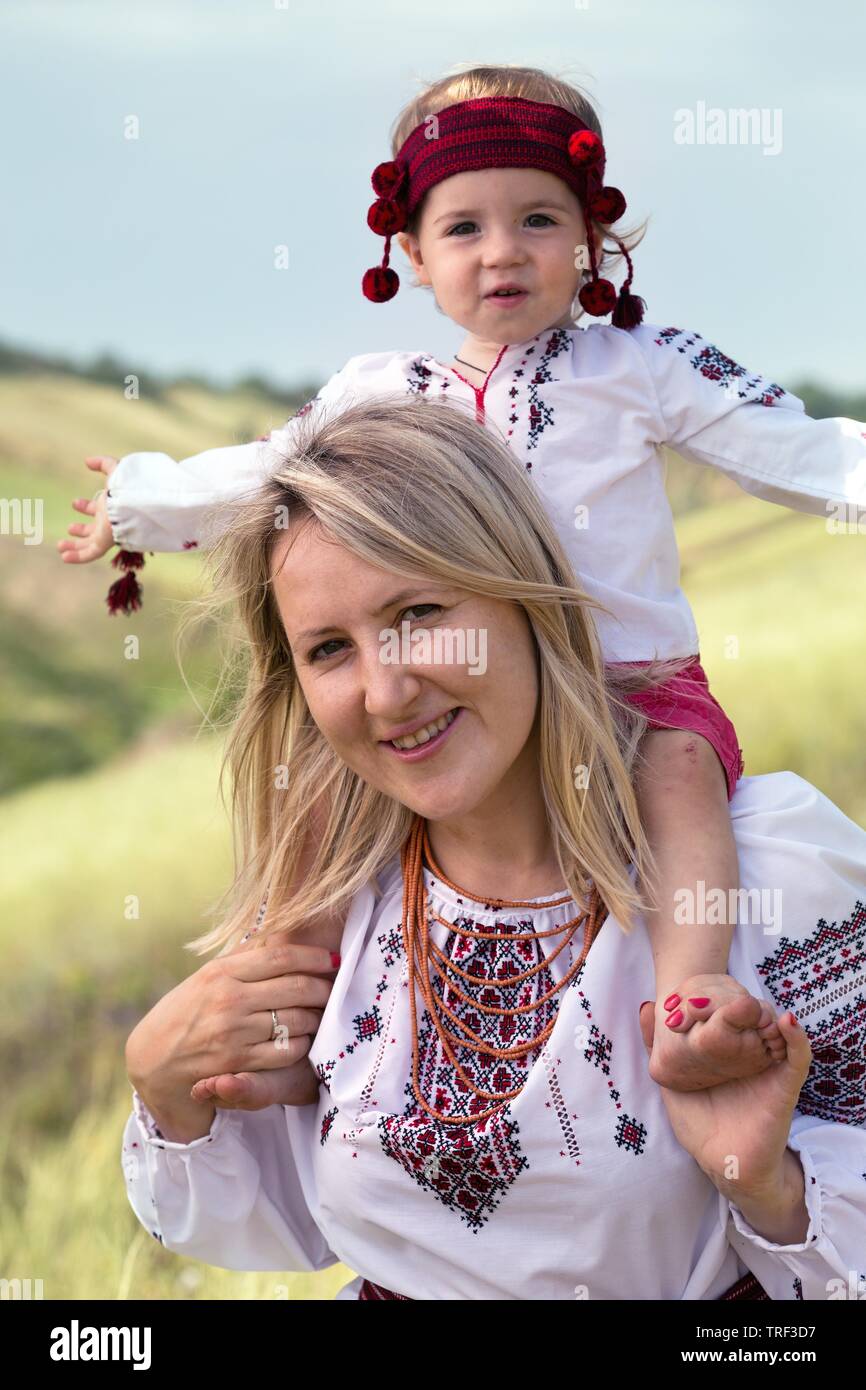 Ukrainian family at the outdoor. mom and daughter in traditional ...