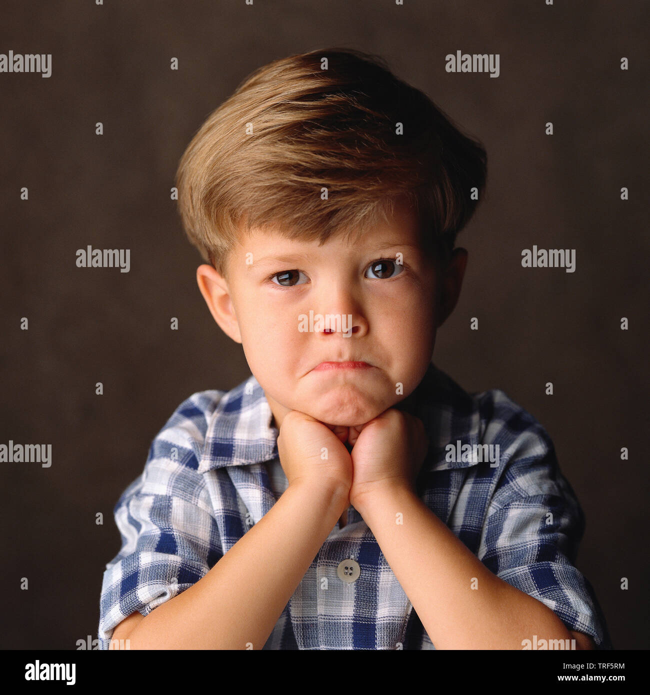 Young boy sitting at table crying Stock Photo - Alamy