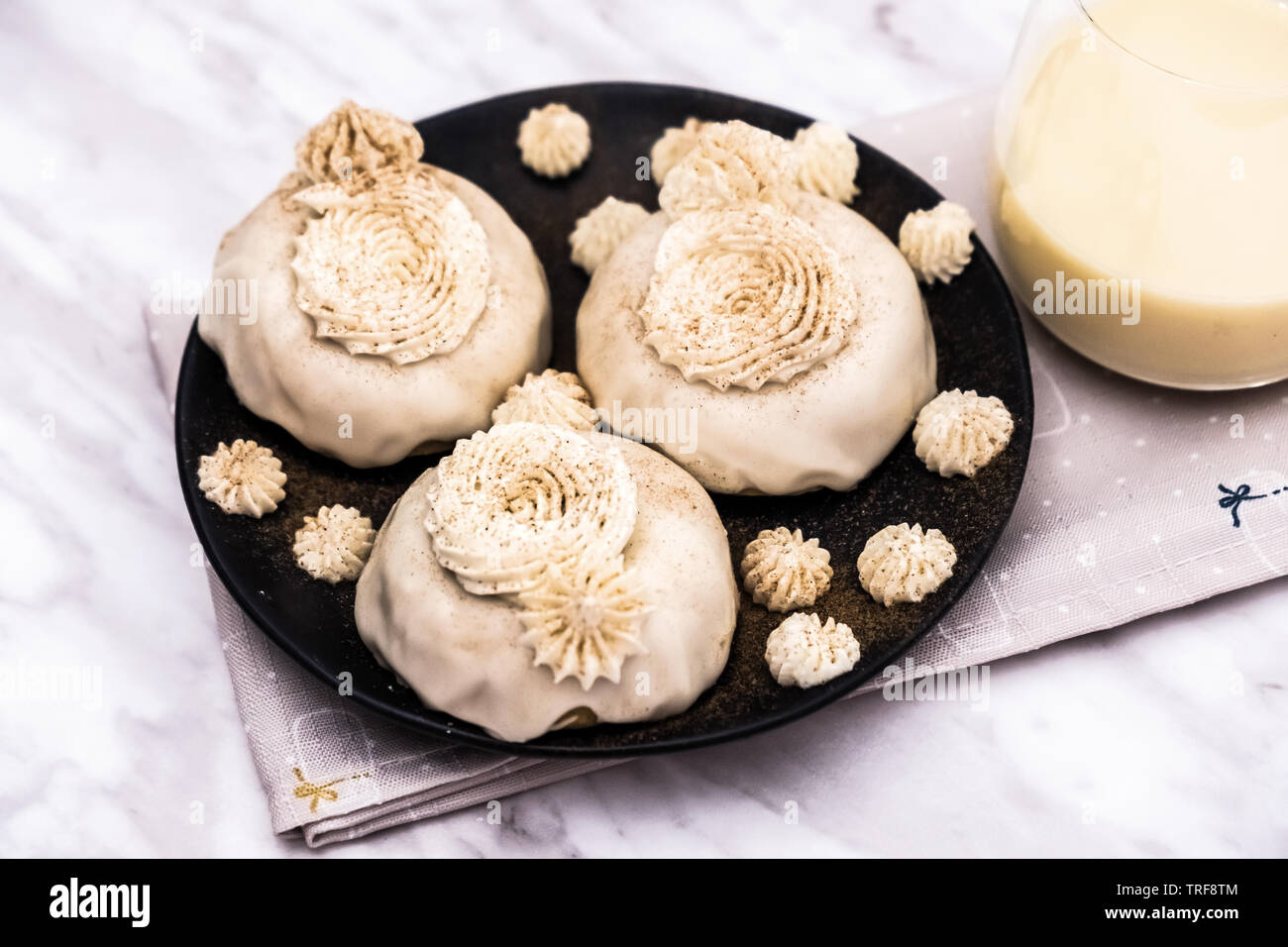 Boozy Eggnog Doughnuts on Black Ceramic Plate over White Marble ...