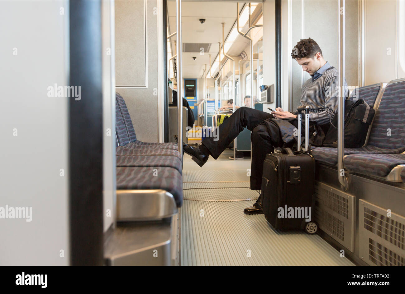 Commuter checking his mobile phone hi-res stock photography and images ...
