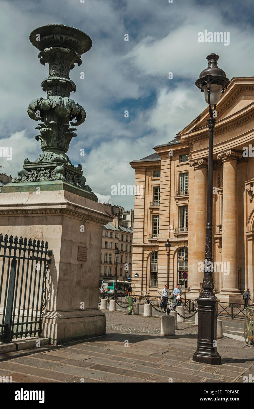 People in front of building, fence decoration and lighting post in ...