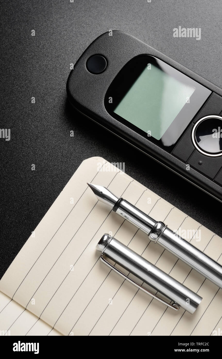 Phone, pen, notepad. Contact us concept Stock Photo - Alamy
